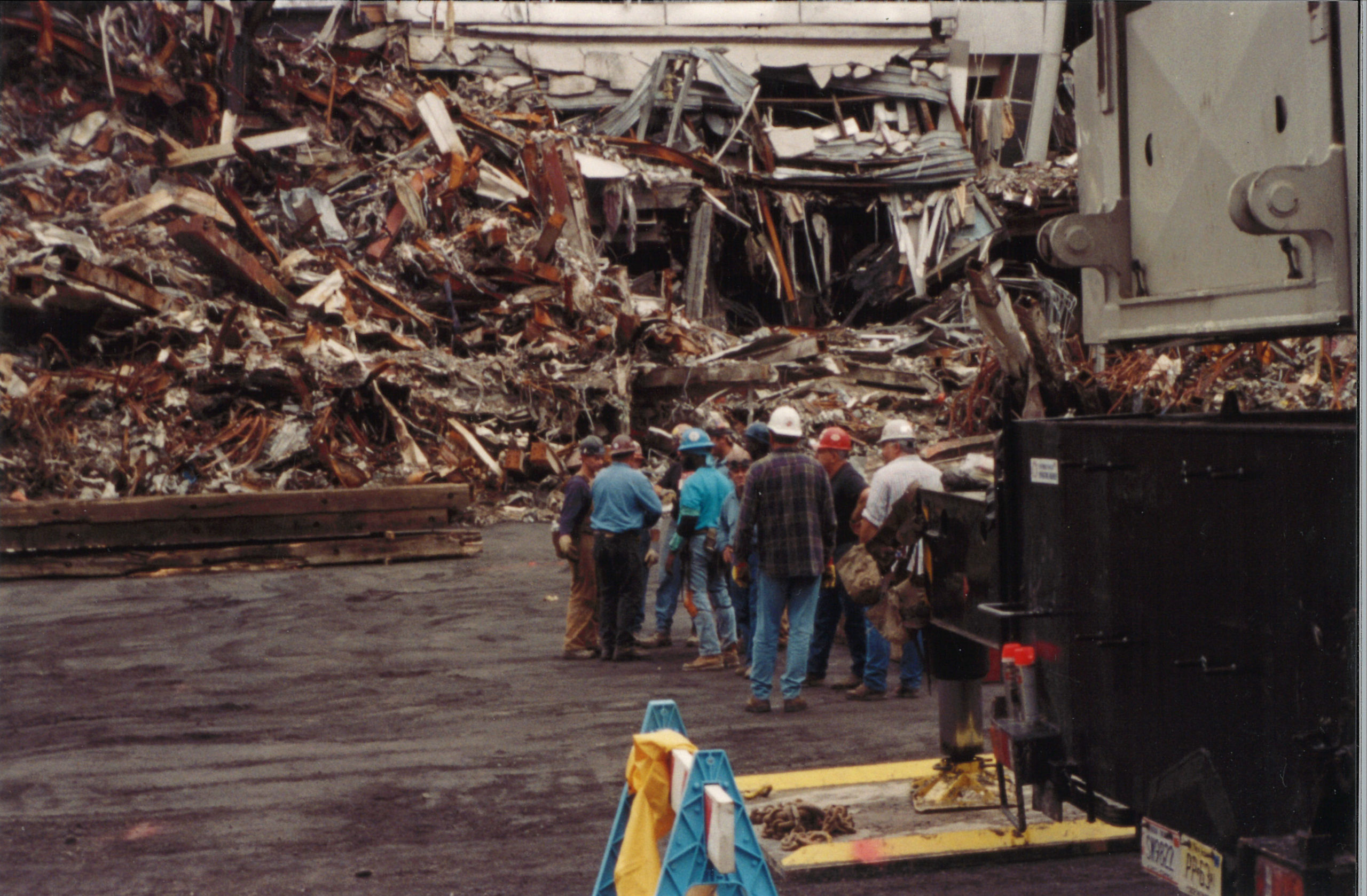 A Group of Workers Standing Beside Debris at Ground Zero - Village ...