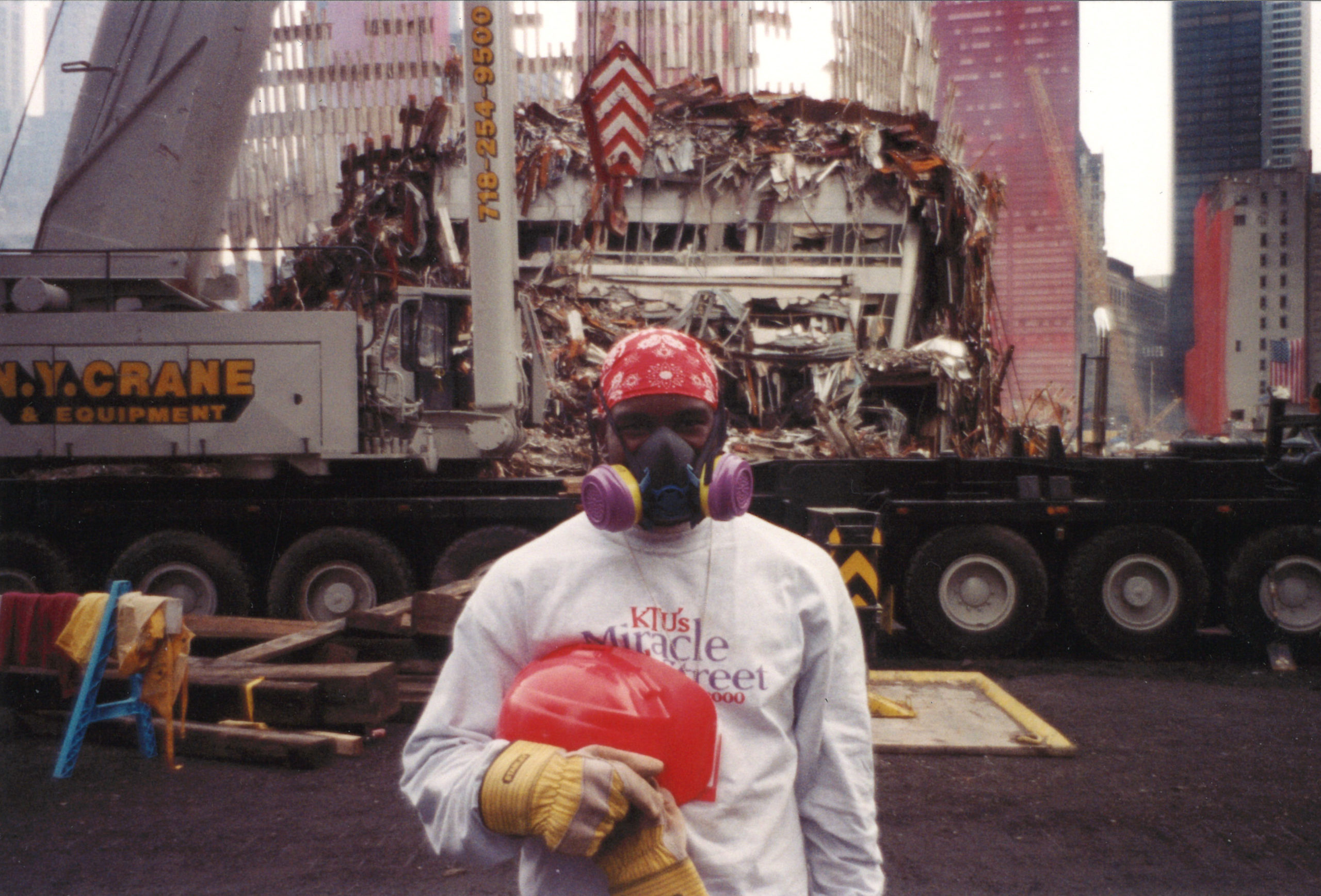An Unknown Worker Wearing a Gas mask in front of the Crumbling WTC ...