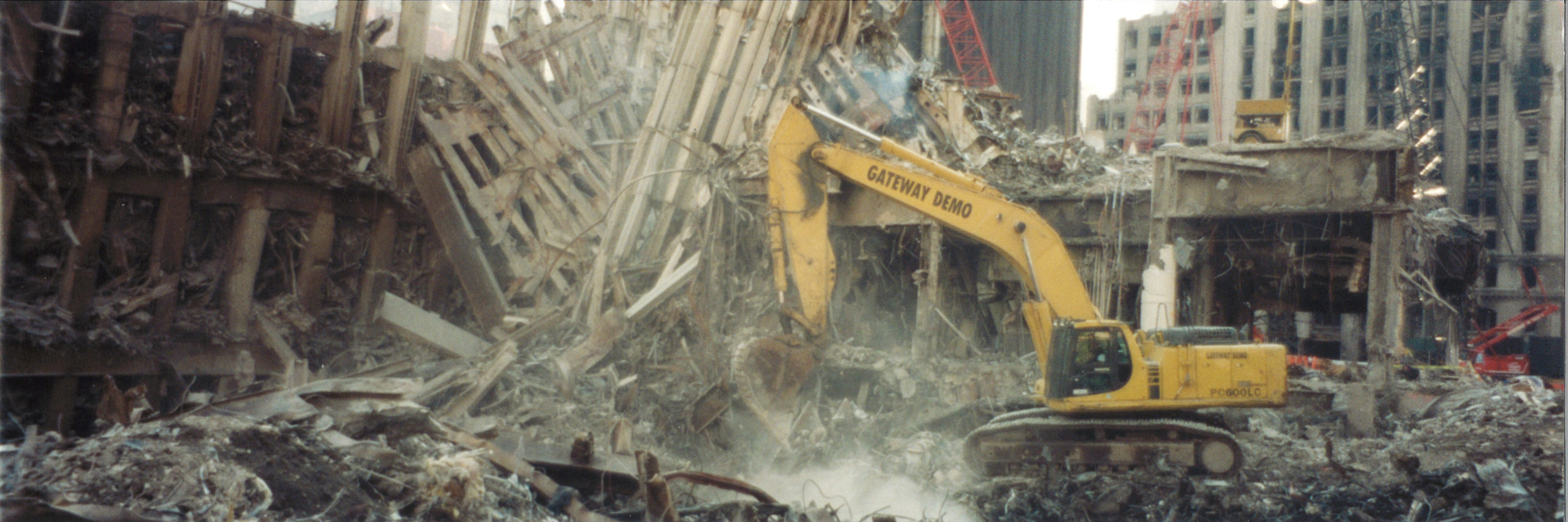 Crane Digging Through Debris at Exoskeleton - Village Preservation