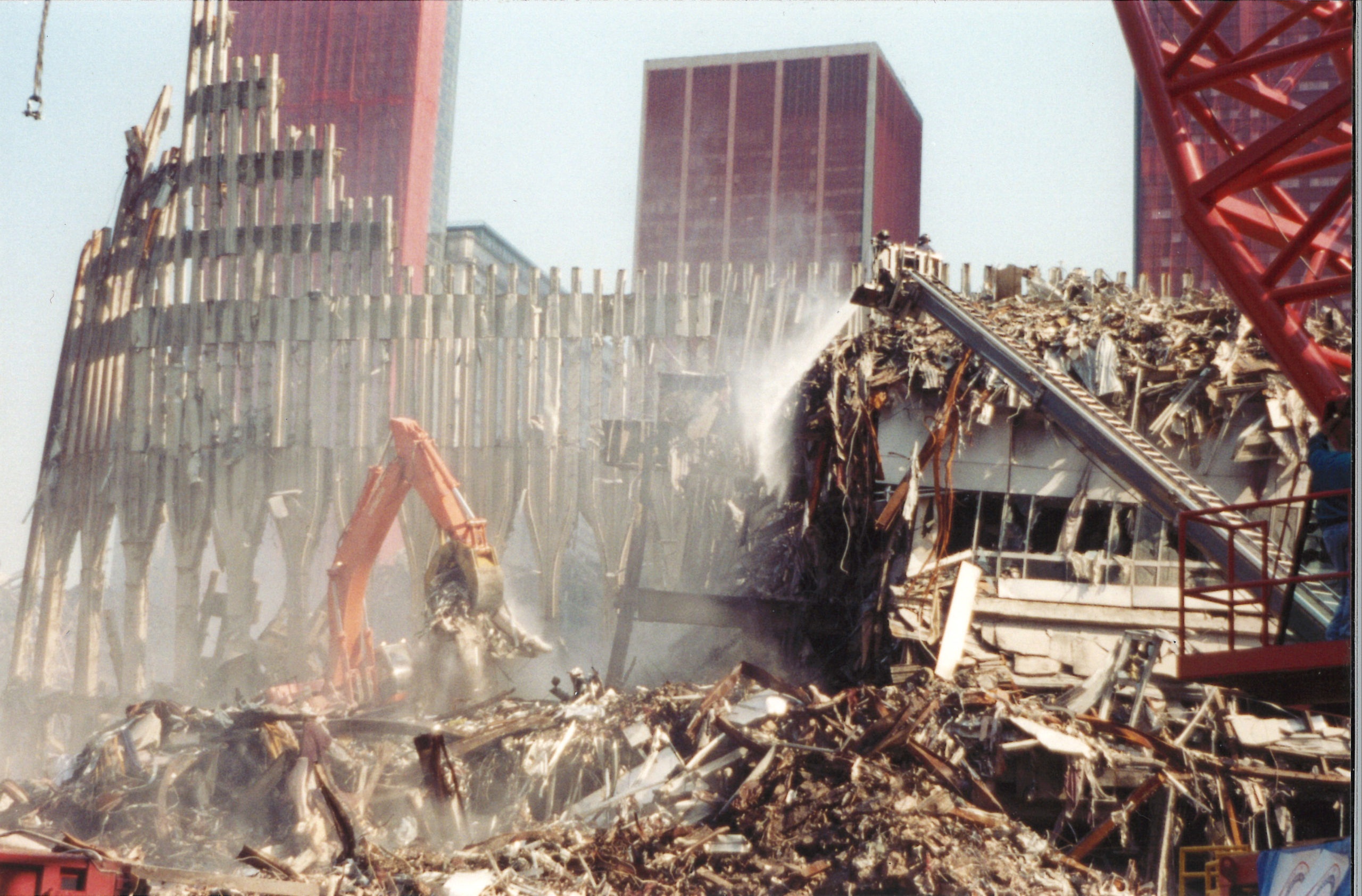 Diggers Moving Debris Next to Falling Exoskeleton - Village Preservation