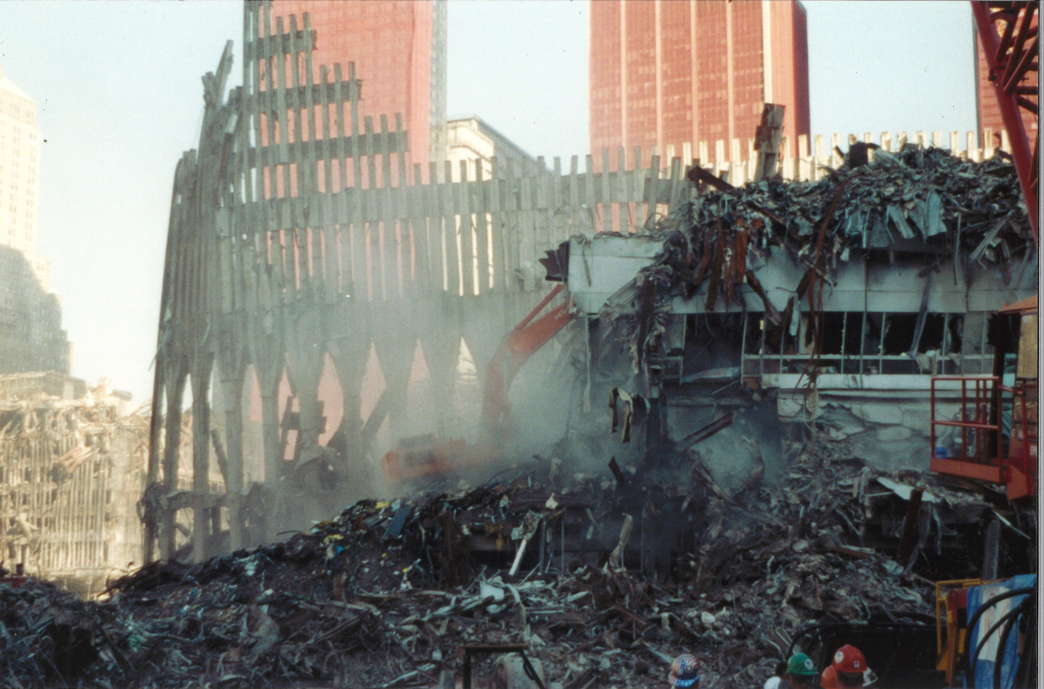 Falling Debris with the Destroyed Exoskeleton of the WTC in the Back ...