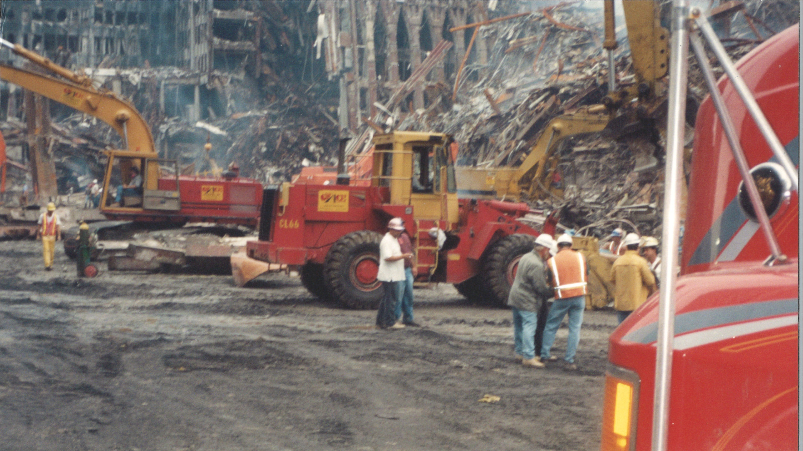 Ground Level Shot of Workers Surrounded by Work Trucks at Ground Zero ...