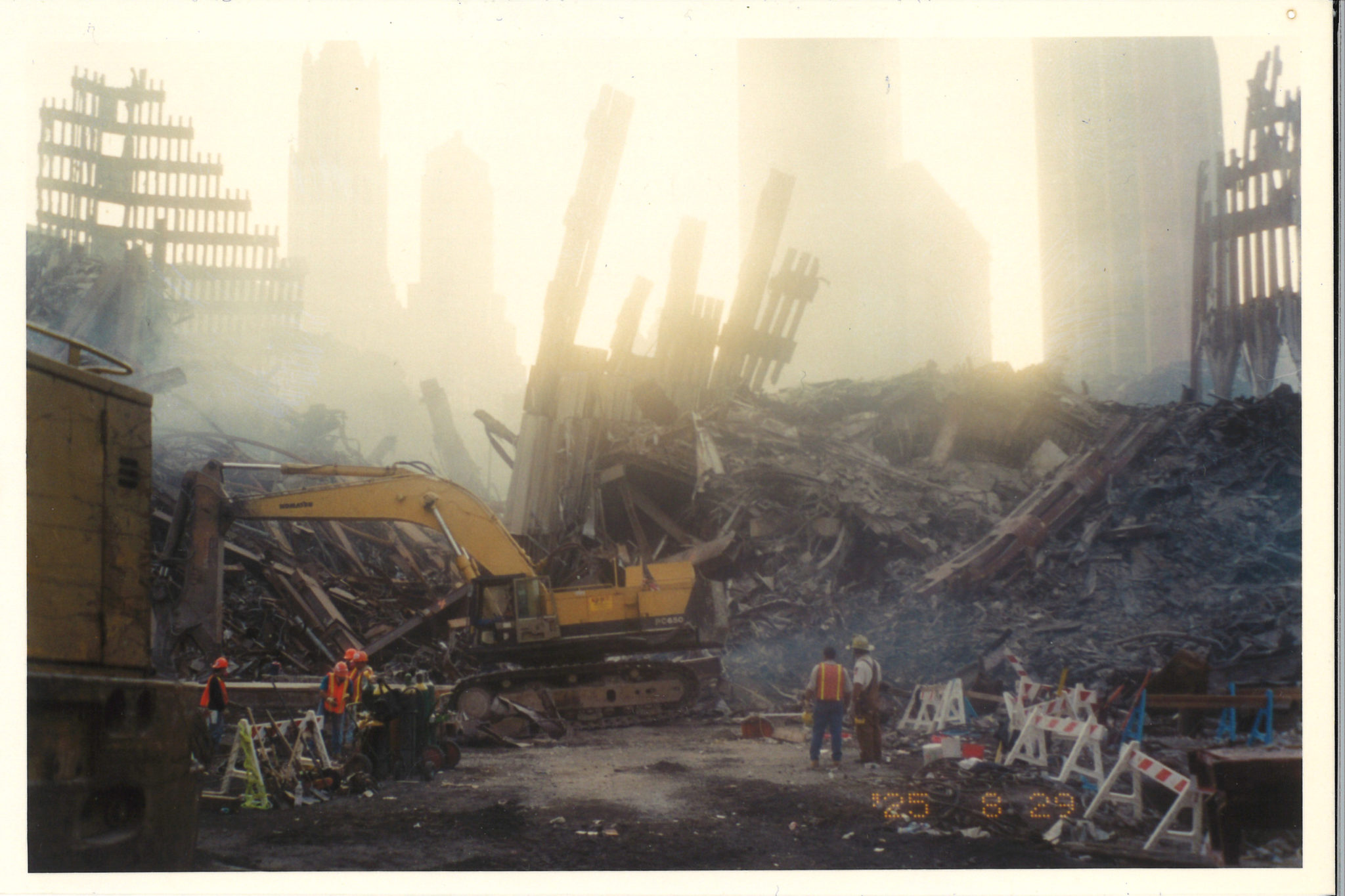 Smoky image of workers at Ground Zero with skeletal remains of WTC ...