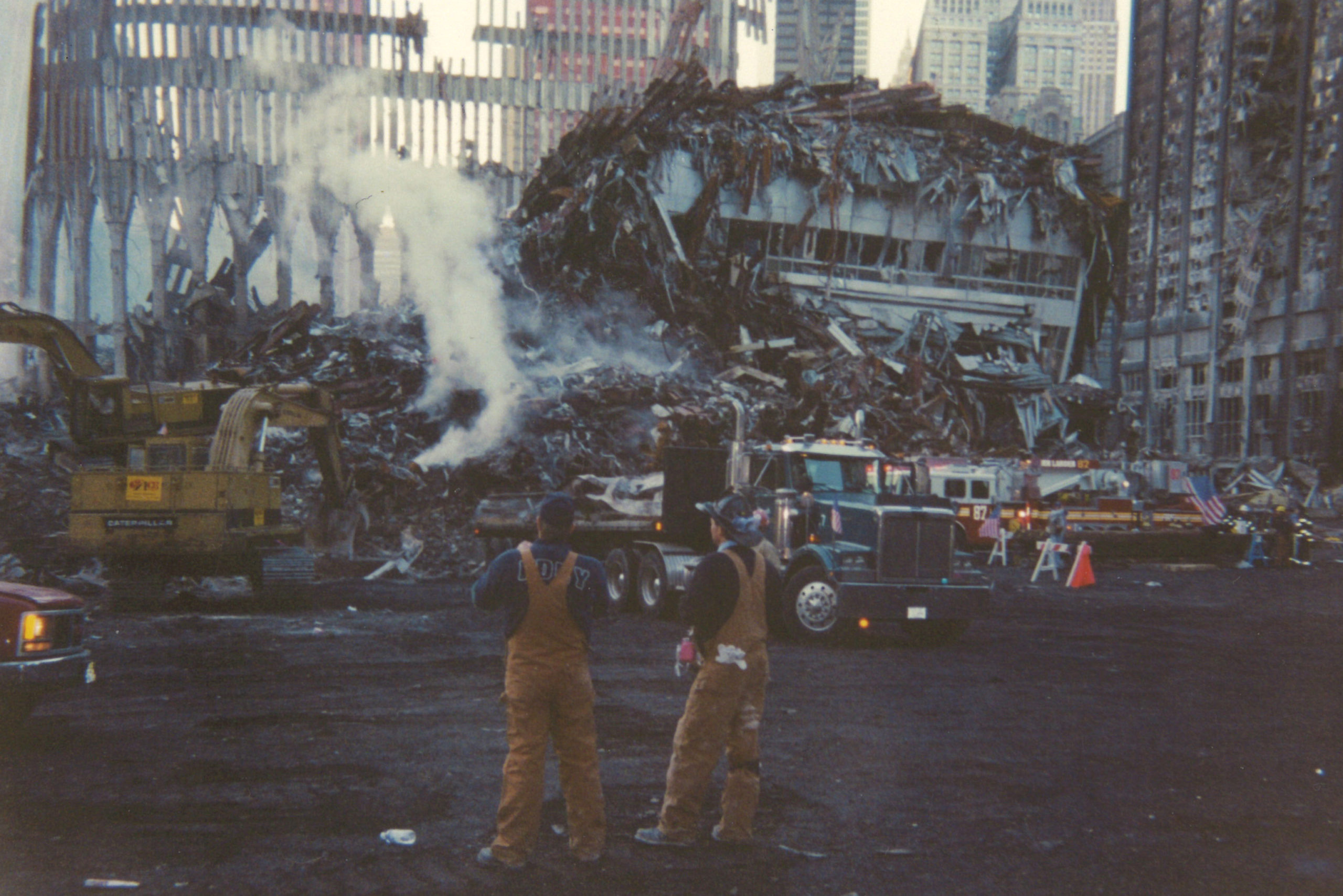 Workers at Ground Zero looking east with Ladder 87 in background ...