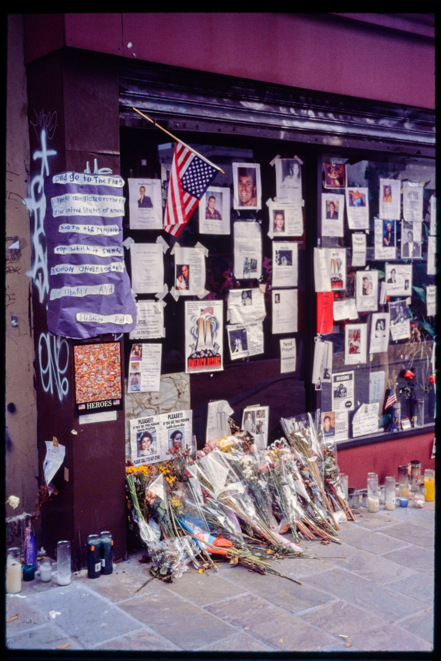 Memorial and Missing Persons Wall on the Side of Building, Flowers and ...