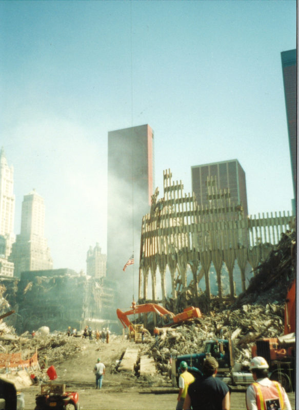 Destruction at Ground Zero with Workers Overlooking - Village Preservation
