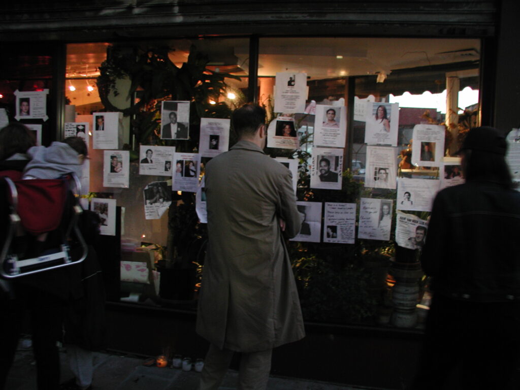 People view missing persons wall - Village Preservation